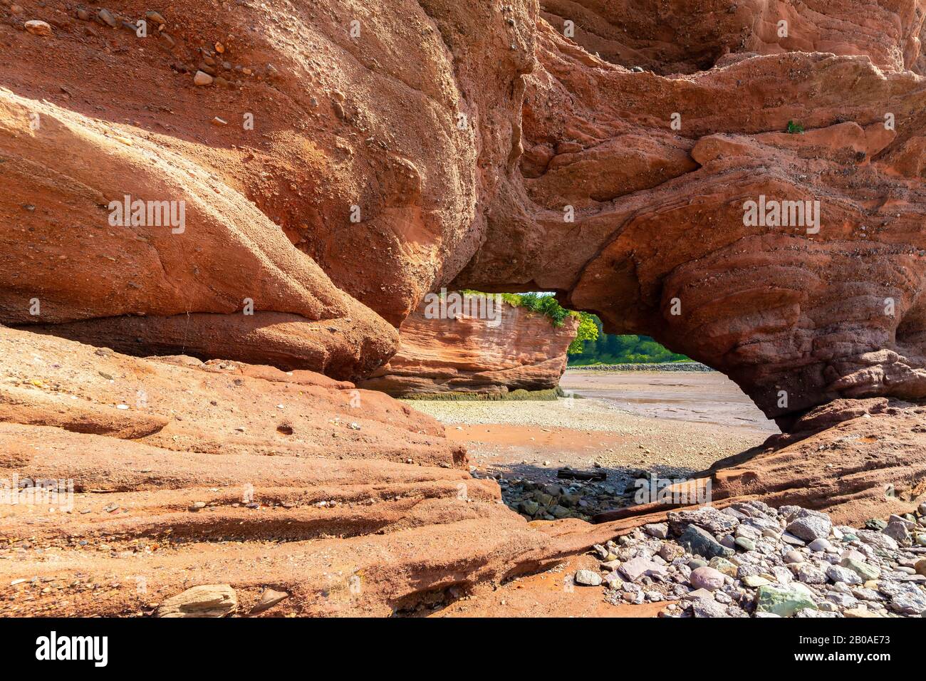 A hole eroded in a sandstone cliff. The hole goes all the way through ...