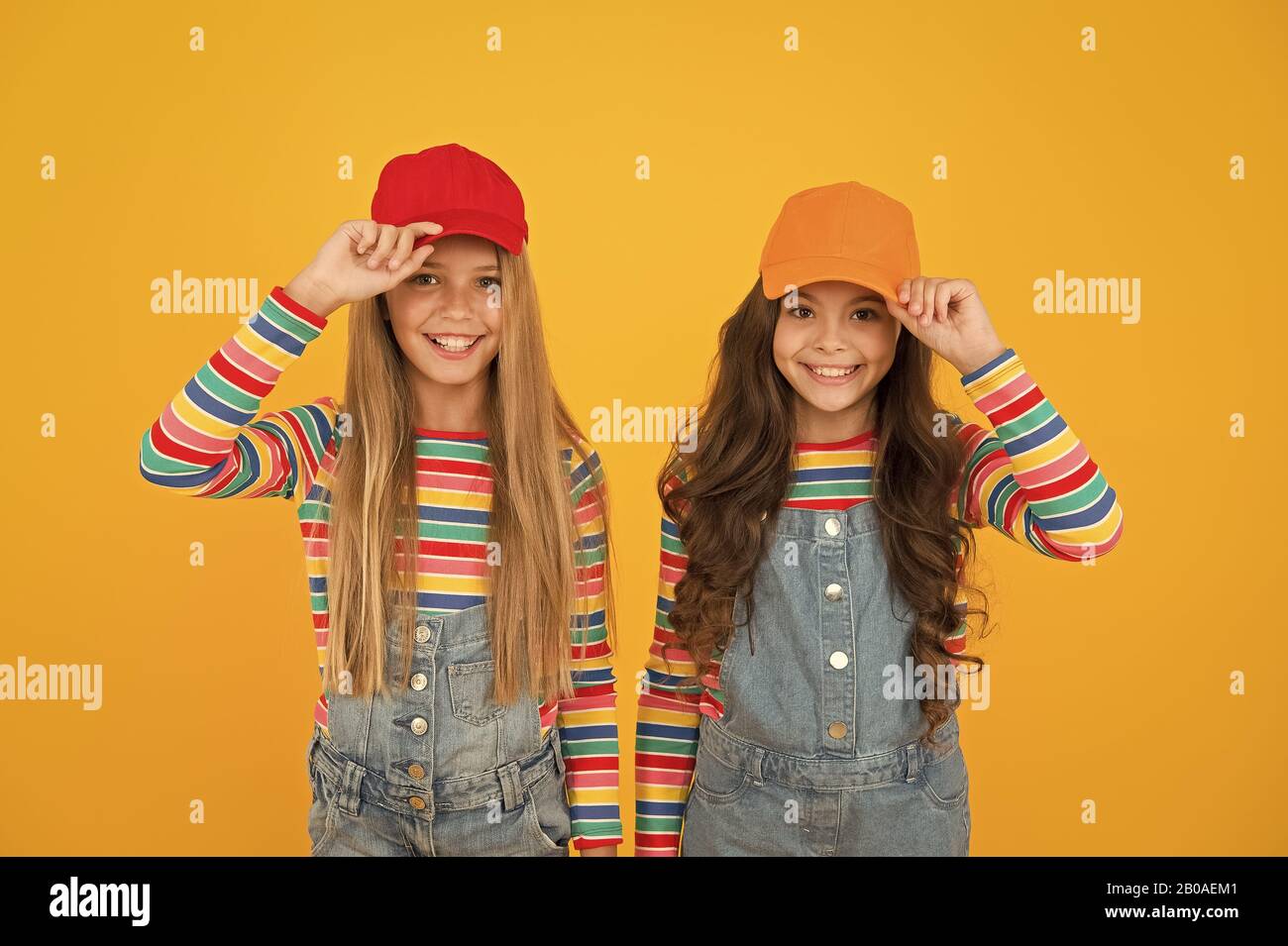 Modern fashion. Kids fashion. Girls long hair wear cap. Cute children ...