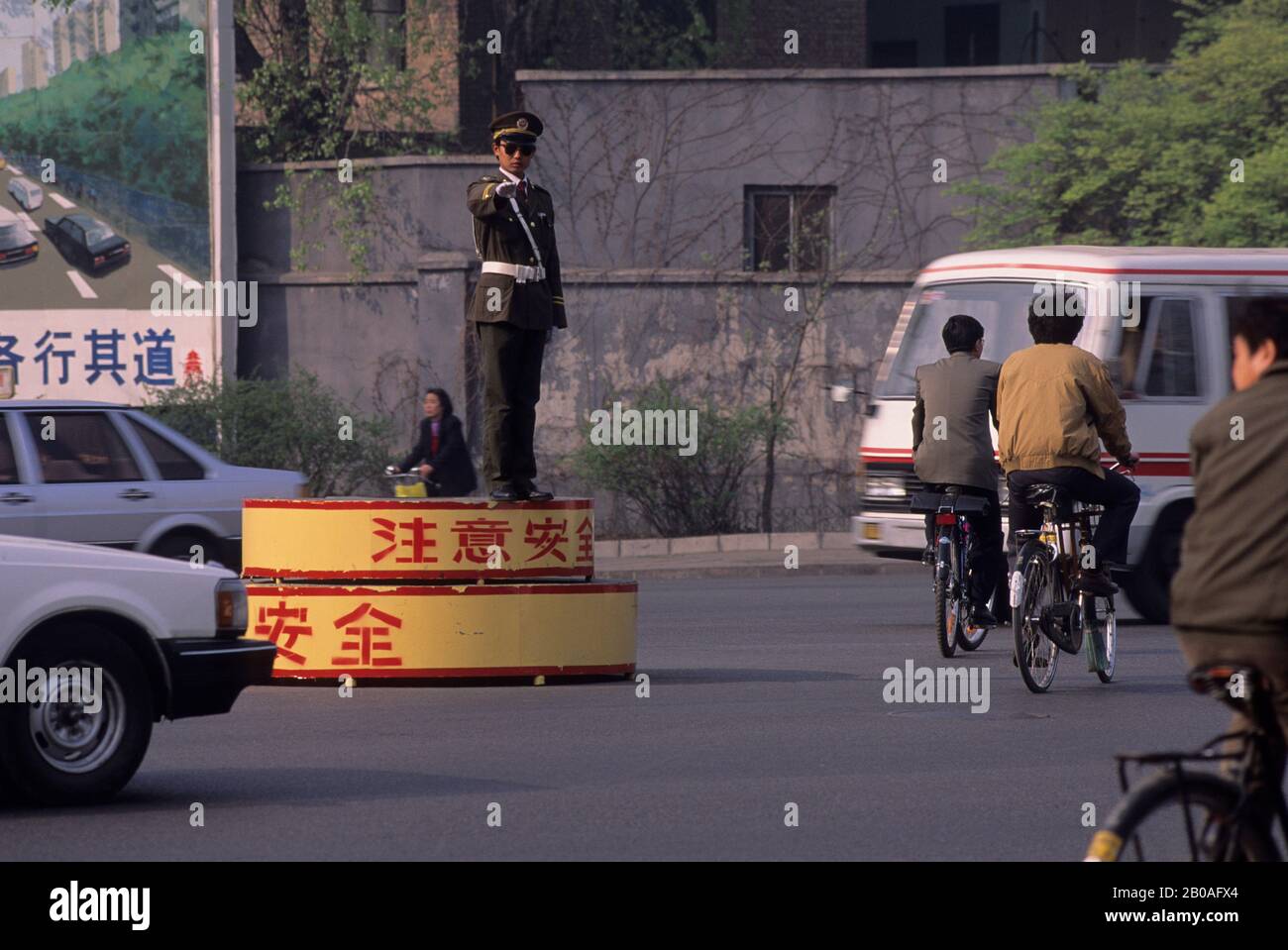 CHINA, BEIJING, STREET SCENE, POLICEMAN DIRECTING TRAFFIC Stock Photo ...