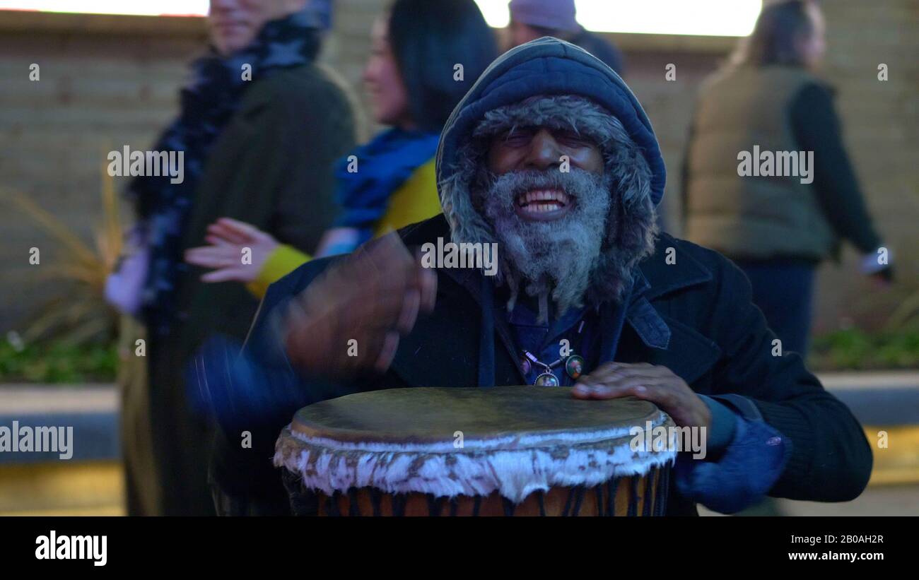 homeless Guy performs as a Street musician at London Leicester Square ...