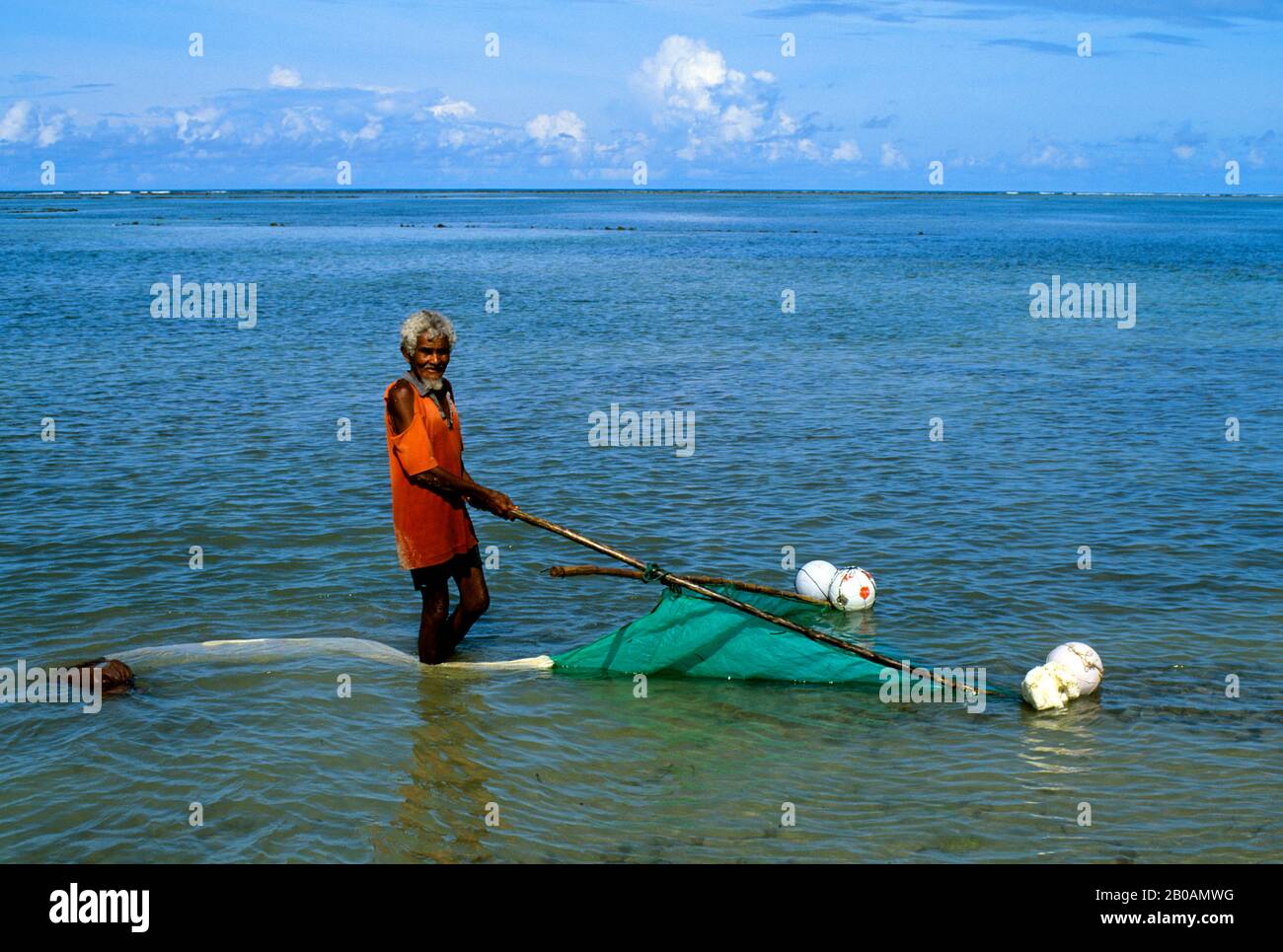 INDONESIA, SAWU (SEBA) ISLAND FISHERMAN SCOOPING NET OVER BOTTOM IN ...
