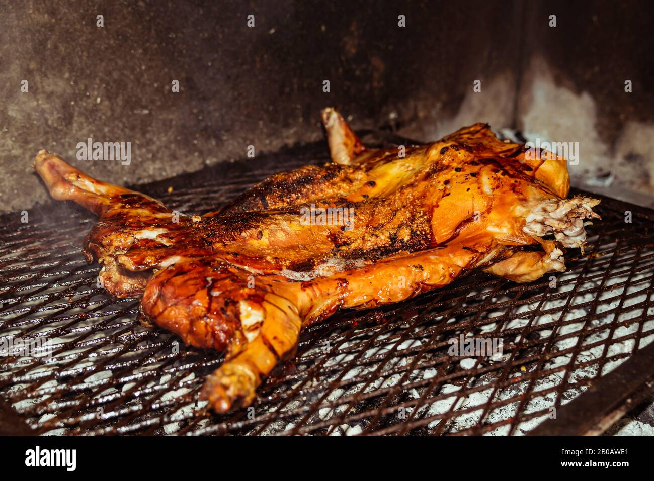 Traditional suckling pig cooked on the charcoal grill. The little pig ...