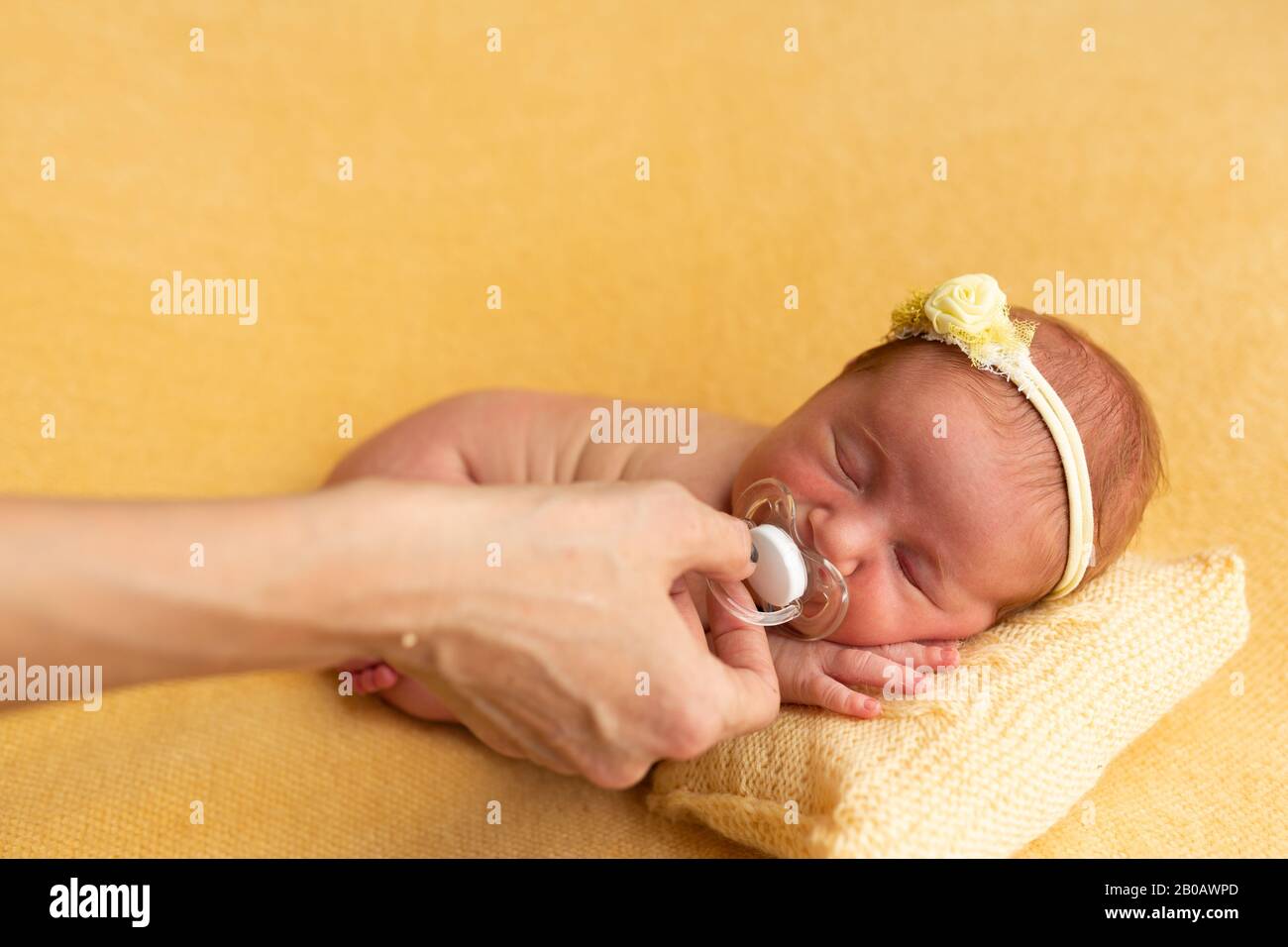mother giving a pacifier to her newborn daughter Stock Photo - Alamy