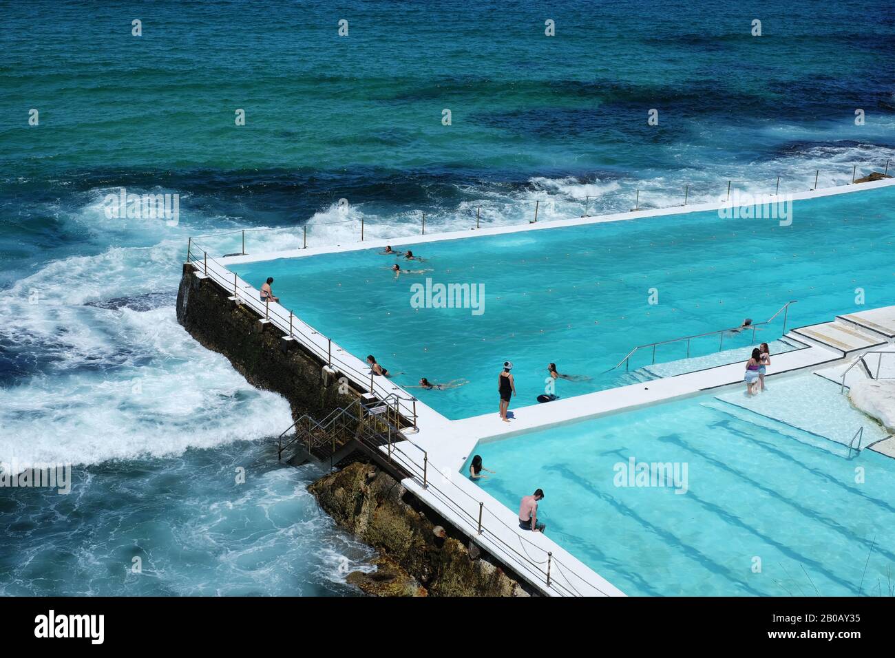 Swimmers at the famous Bondi Icebergs ocean pool, on a sunny day with ...