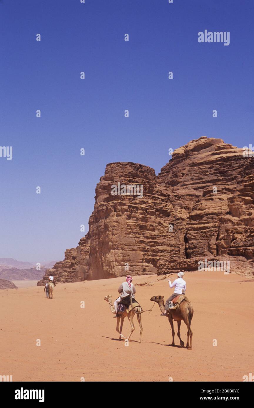 JORDAN, WADI RUM, TOURIST ON CAMEL RIDE Stock Photo - Alamy