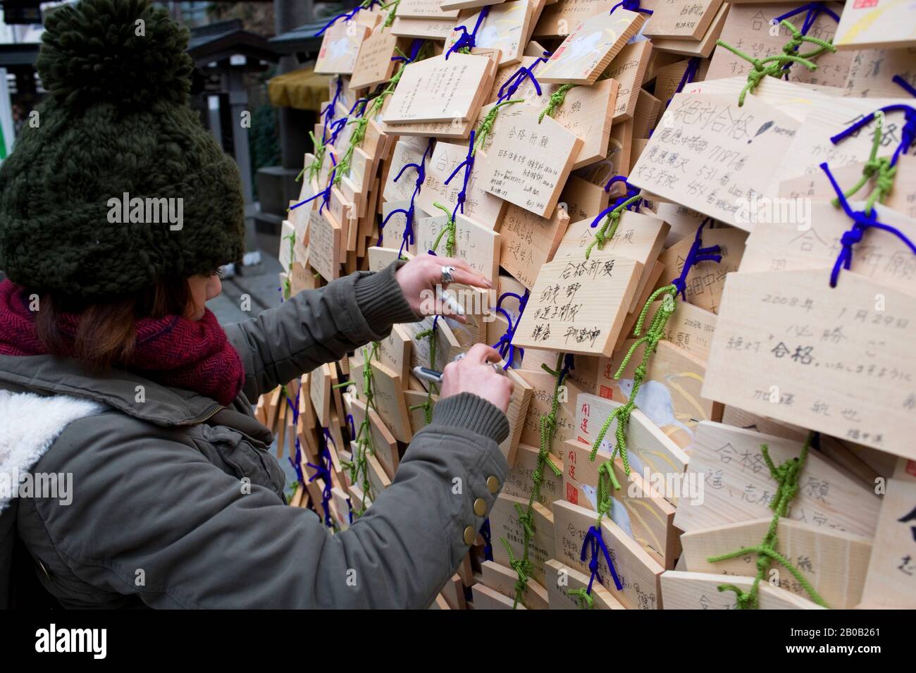 JAPAN, TOKYO, YUSHIMA TENMANGNU SHINTO SHRINE, STUDENT WRITING EMA ...