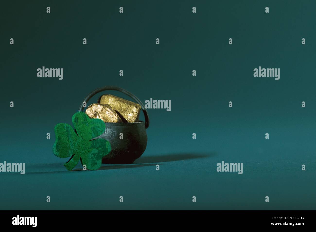Pot of Gold and Wooden Four-Leaf Clover on Turquoise Background Stock ...