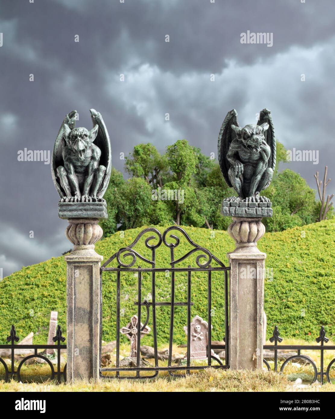 Gargoyle Statues on Iron Gated Cemetery Entrance Stock Photo - Alamy