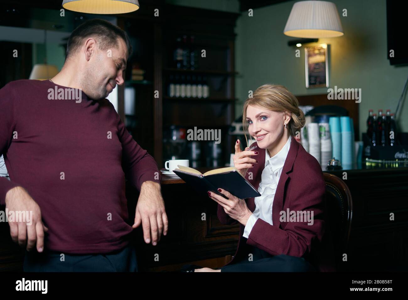 Business people talking over coffee in a cafe Stock Photo - Alamy