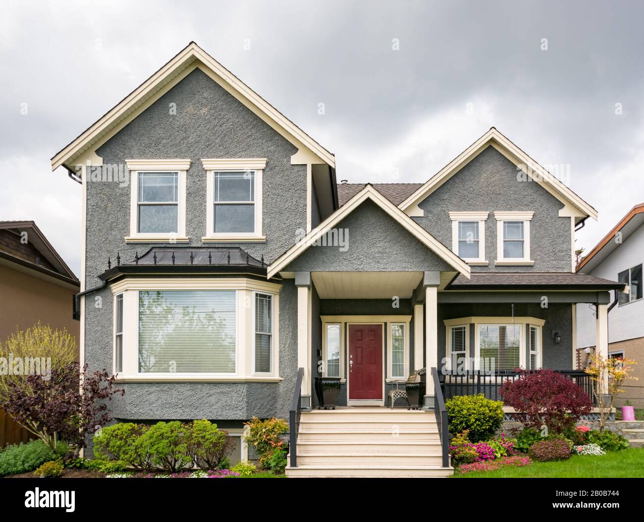 Entrance of average family house with doorsteps to the porch and lawn ...