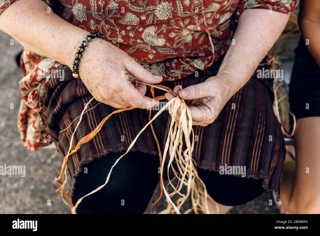 Female weaving basket on the craft workshop. Hands holding the ...