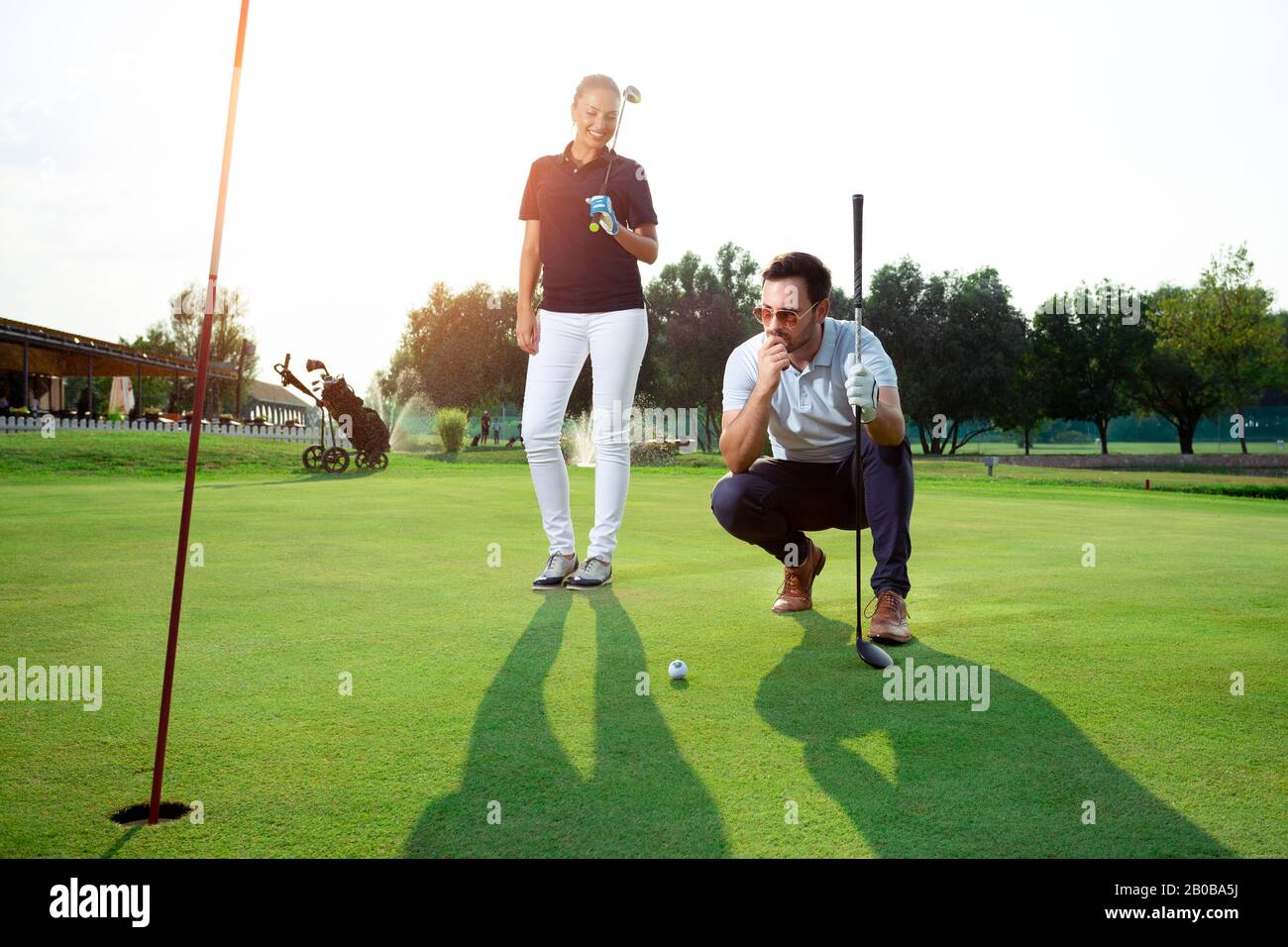 A beautiful couple playing golf Stock Photo - Alamy