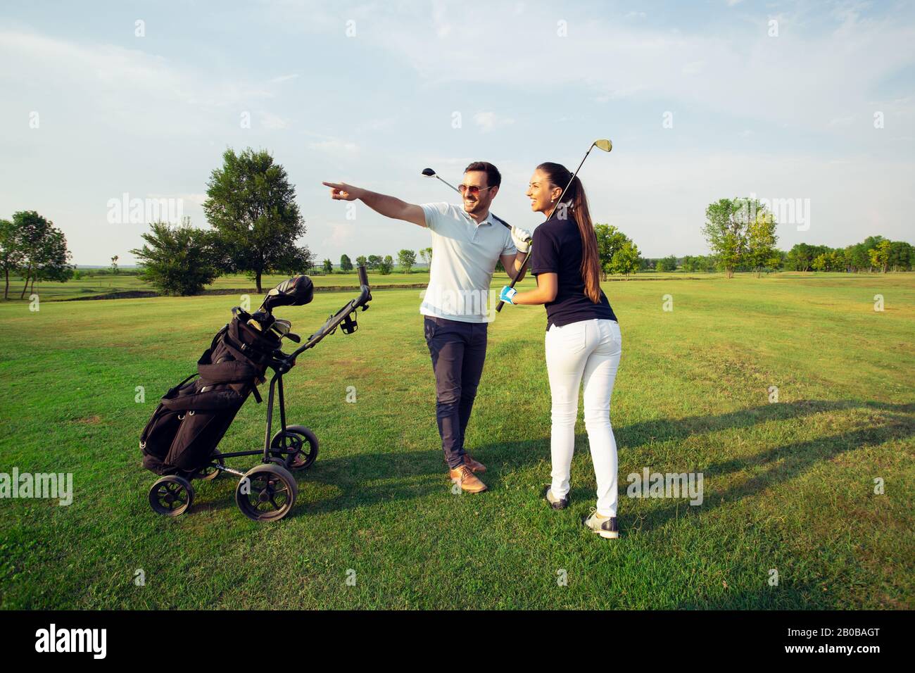 A handsome male golfer is pointing at something in the distance Stock ...