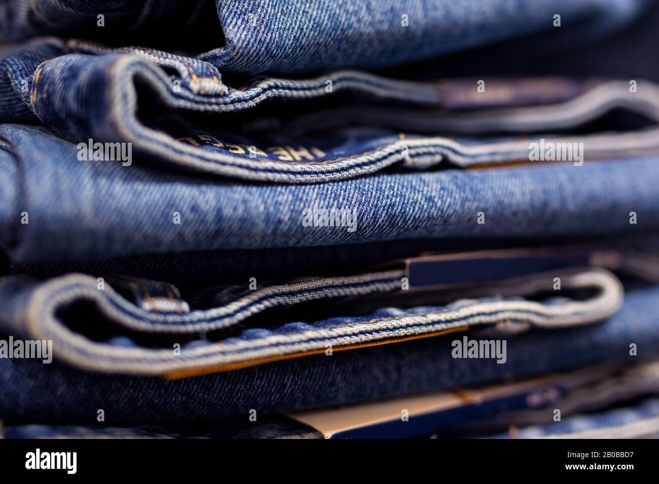 A closeup photo of a stack of a folded jeans Stock Photo - Alamy