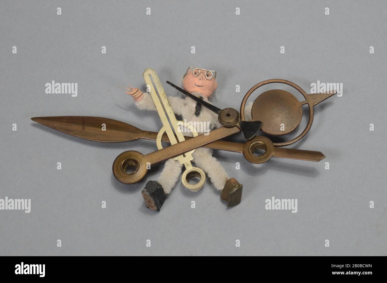 Under pressure of time - little pipe cleaner figurine lays on a grey ...