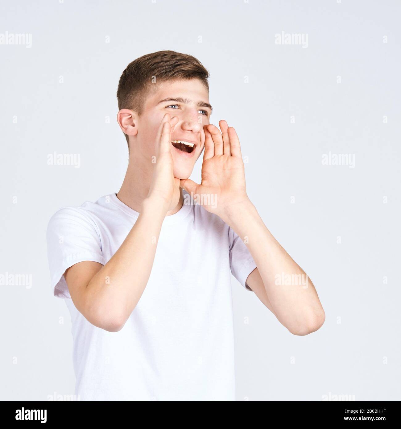Happy teen man yelling loud. Fun voice concept. Adorable boy portrait ...