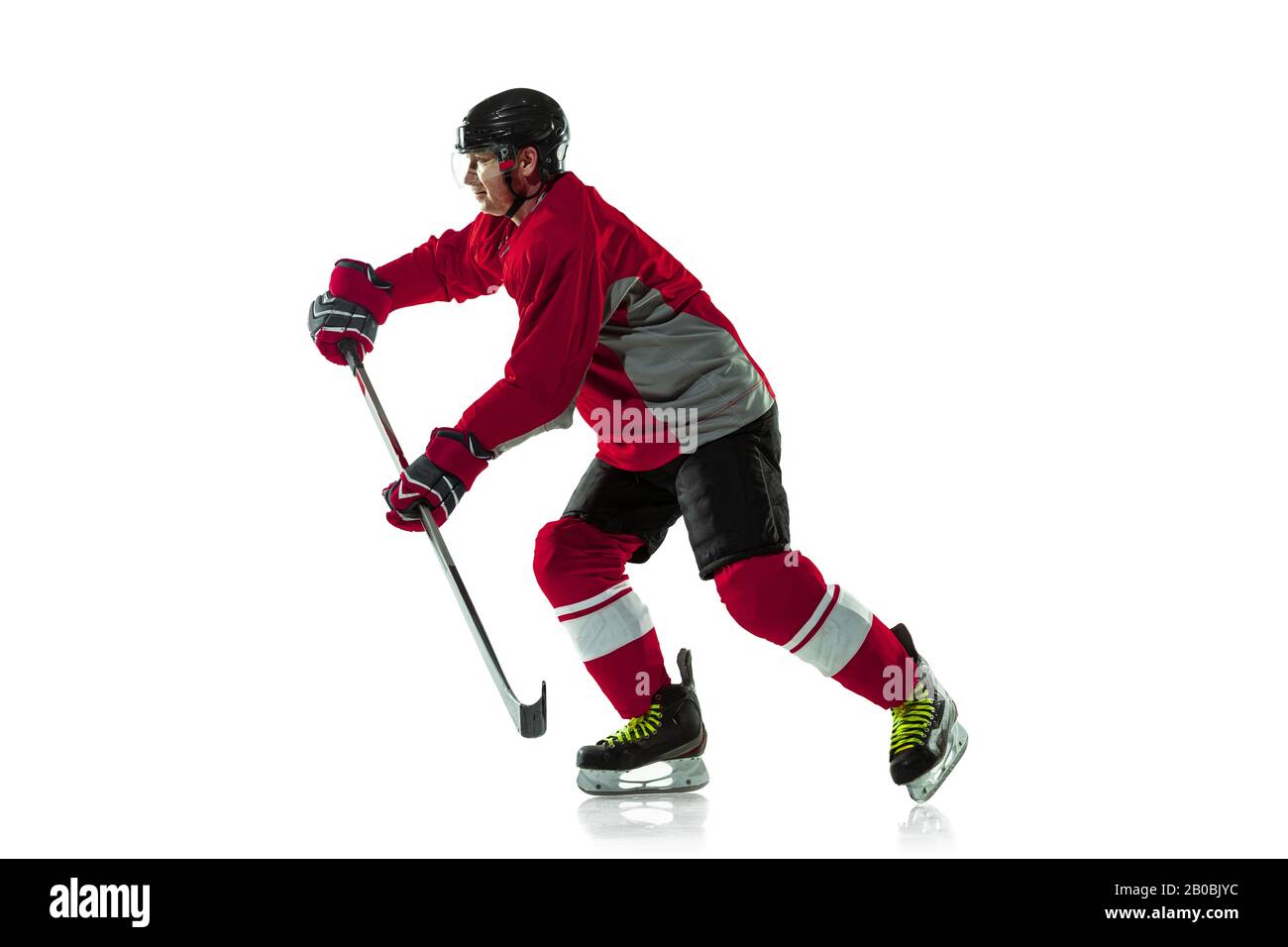 Scoring a goal. Male hockey player with the stick on ice court and ...