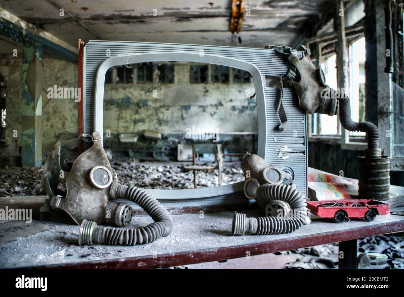 Soviet-era gas masks are hung up on a weathered TV screen in an ...