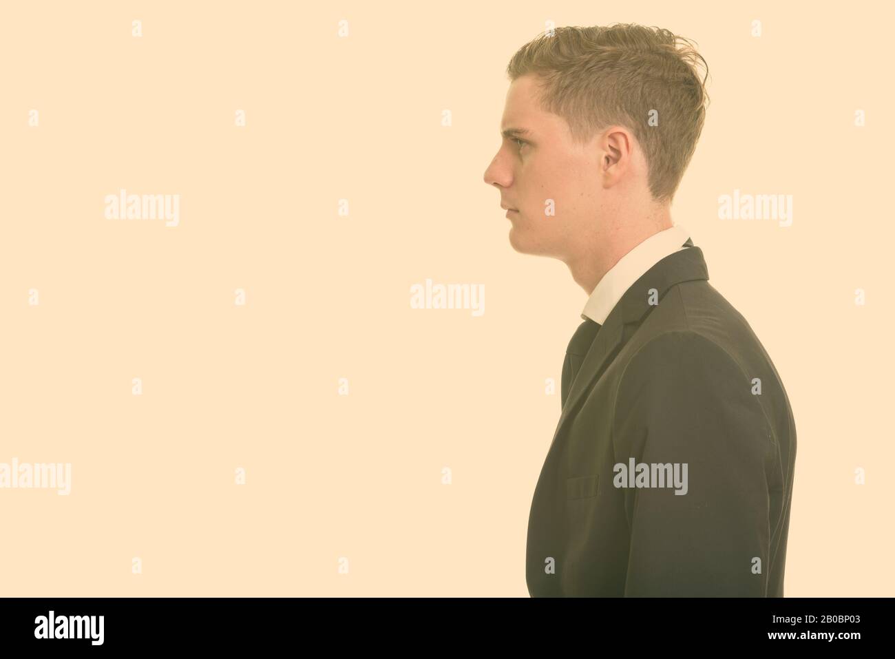 Side view of young handsome Caucasian businessman Stock Photo - Alamy
