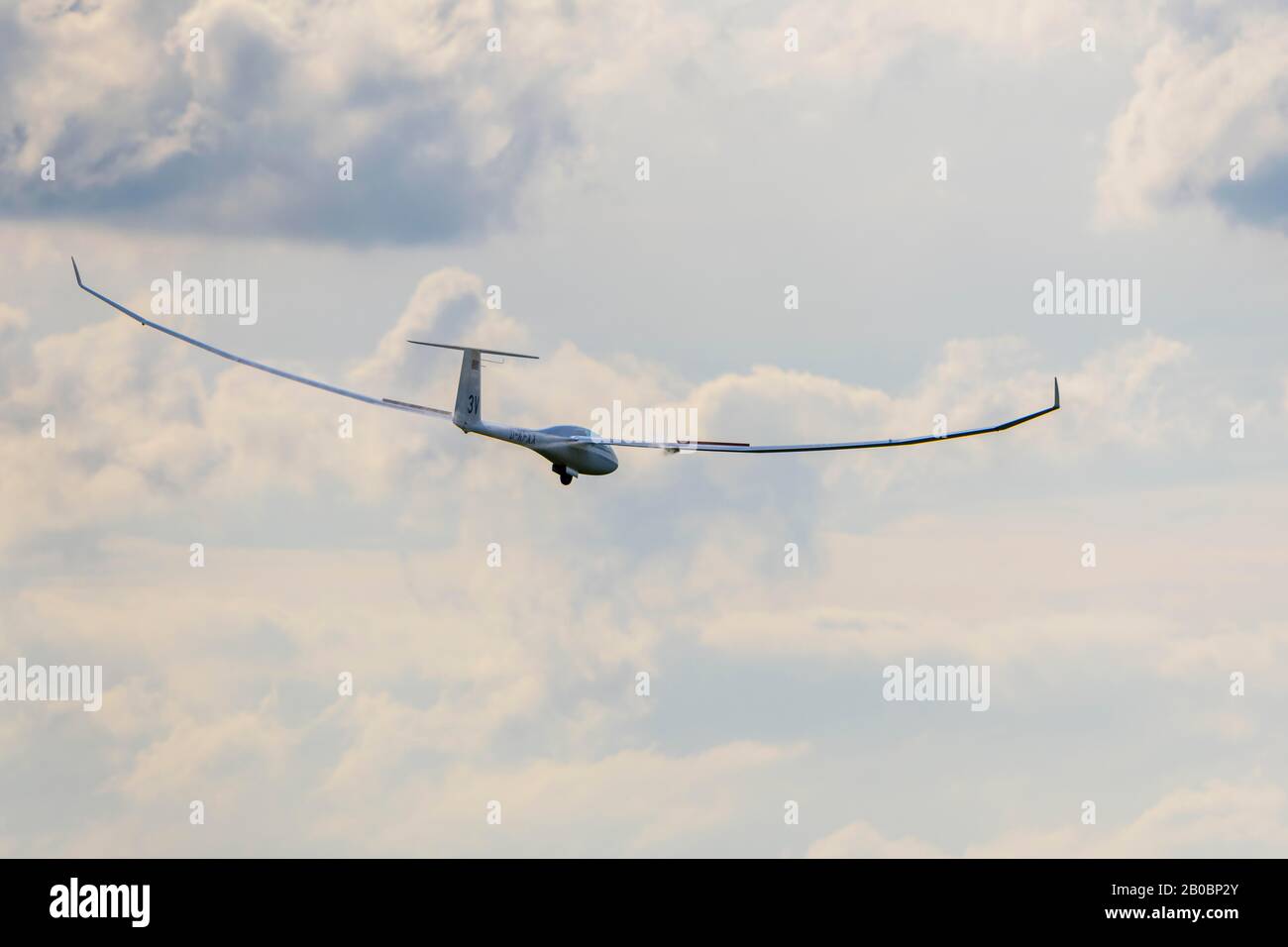 Glider flying in a cloudy sky, Germany Stock Photo - Alamy