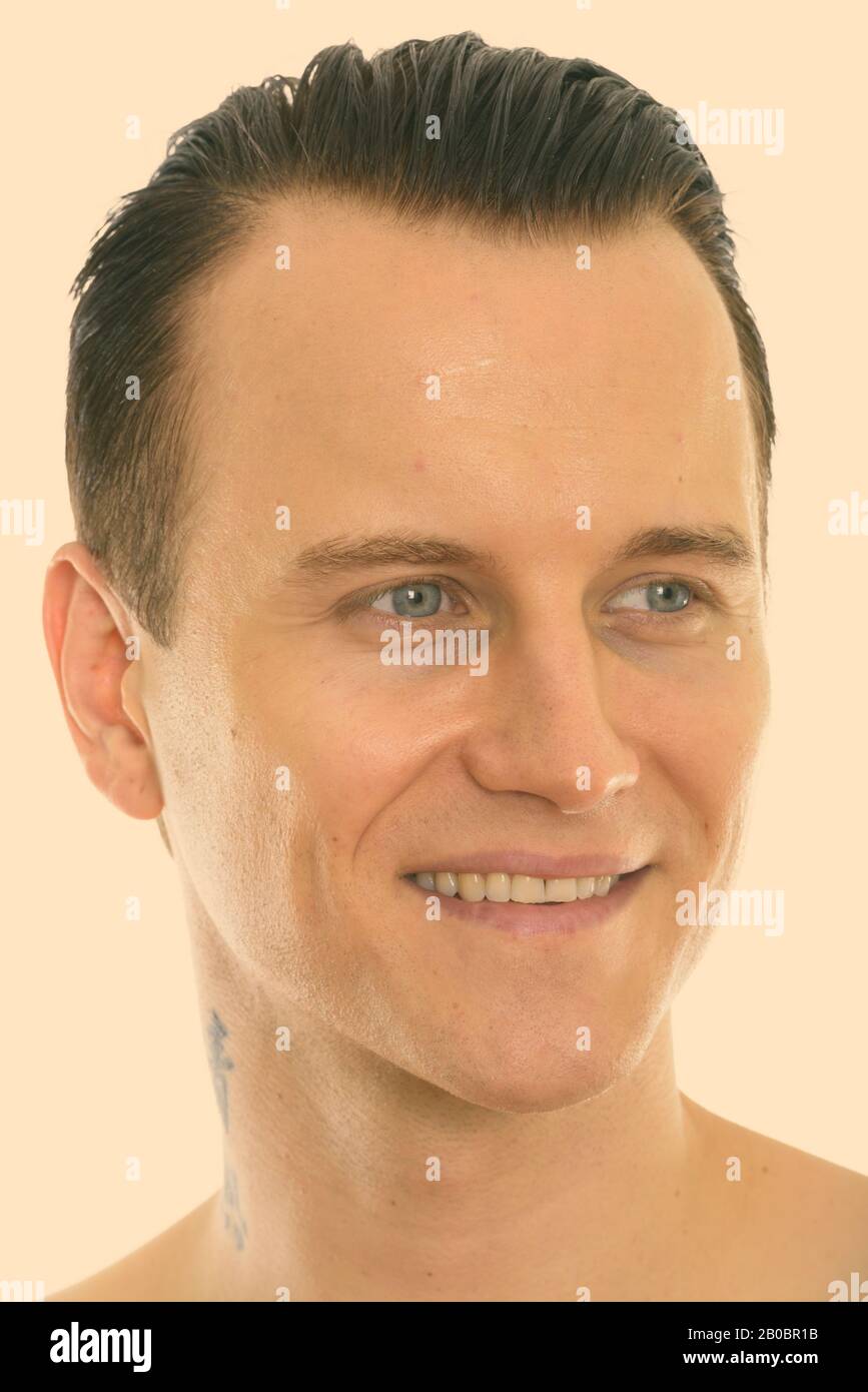 Face of young happy man smiling while thinking Stock Photo - Alamy