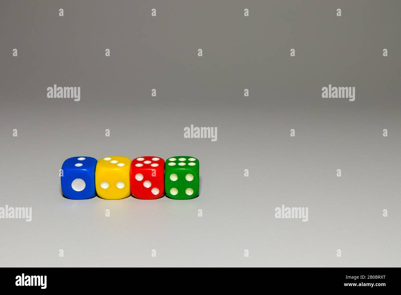 Color dice with numbers on grey background Stock Photo - Alamy