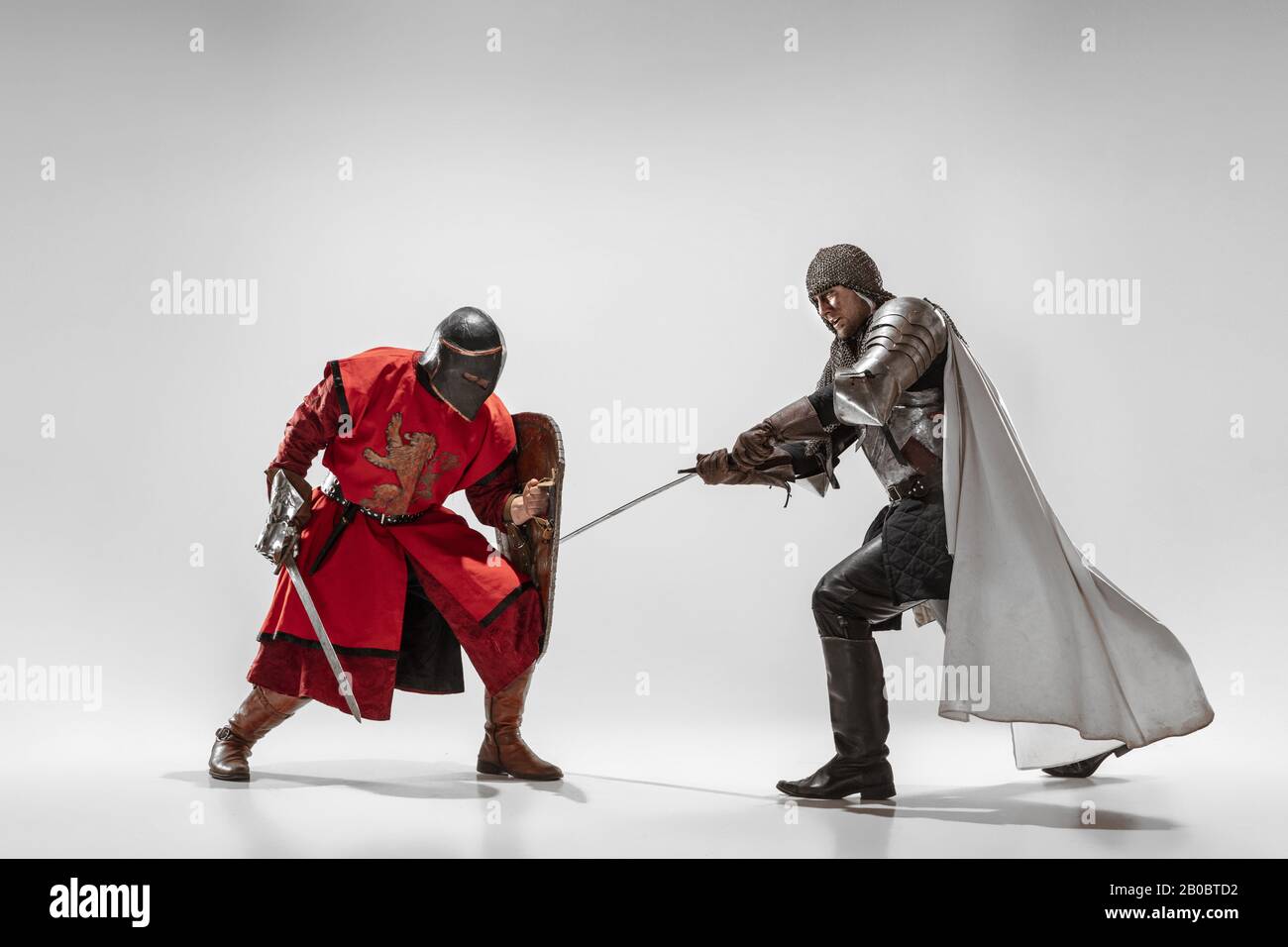 Brave armored knights with professional weapon fighting isolated on ...