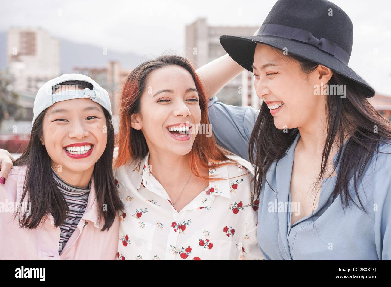 Asian women friends having fun outdoor - Happy trendy girls laughing ...