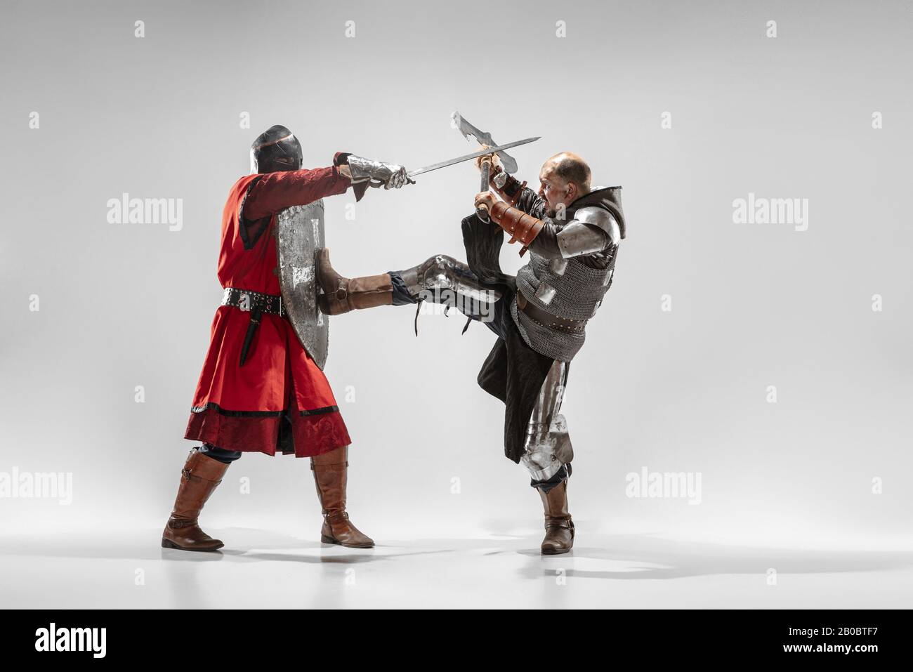 Brave armored knights with professional weapon fighting isolated on ...