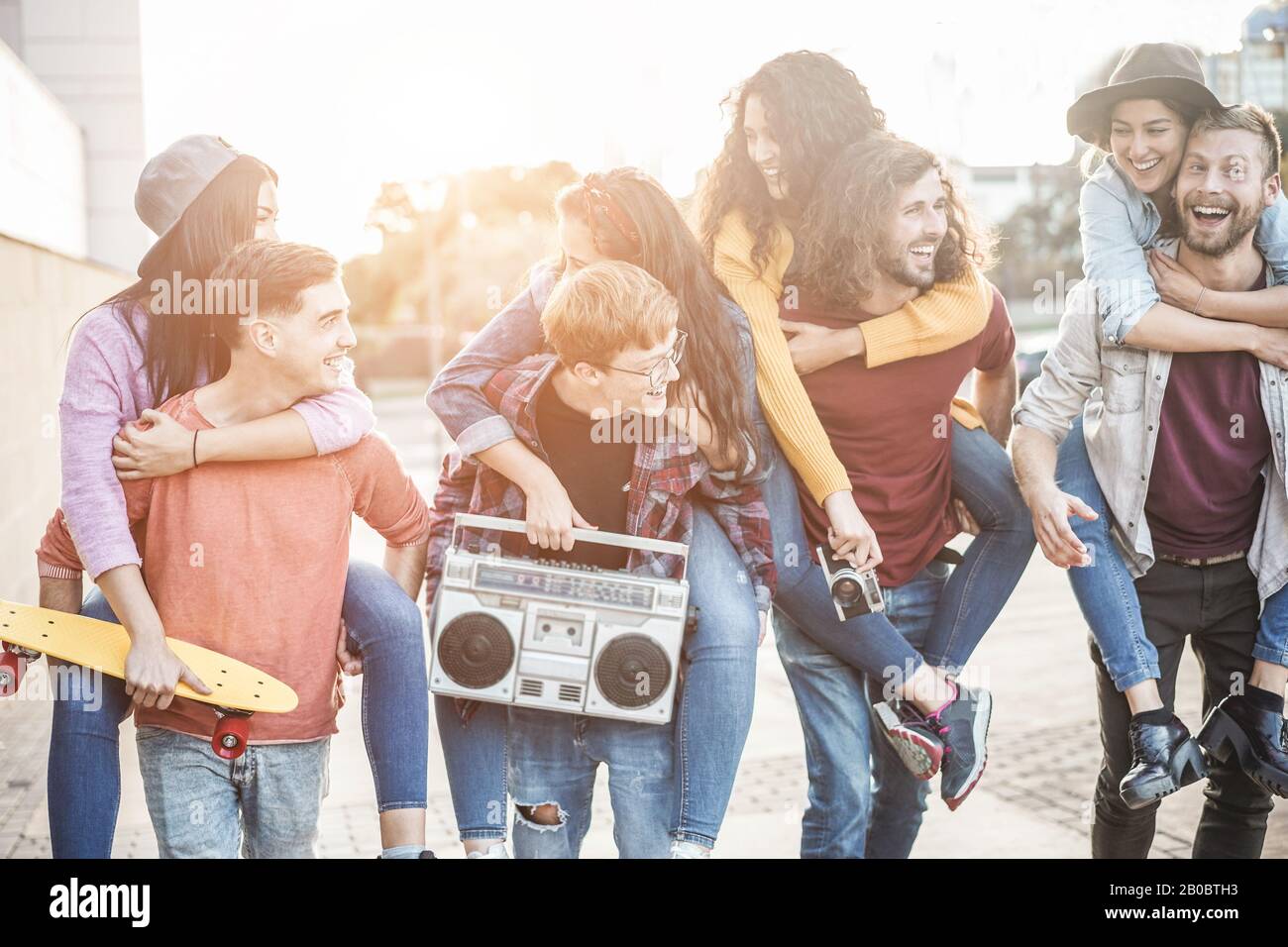 Happy friends having fun walking on city street center outdoor - Young ...