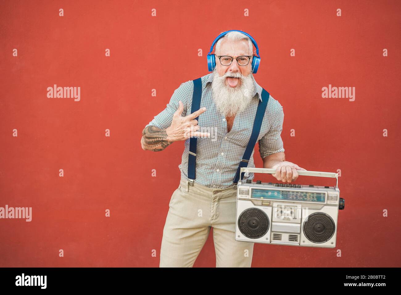 Senior crazy man with boombox stereo playing rock music - Trendy mature ...