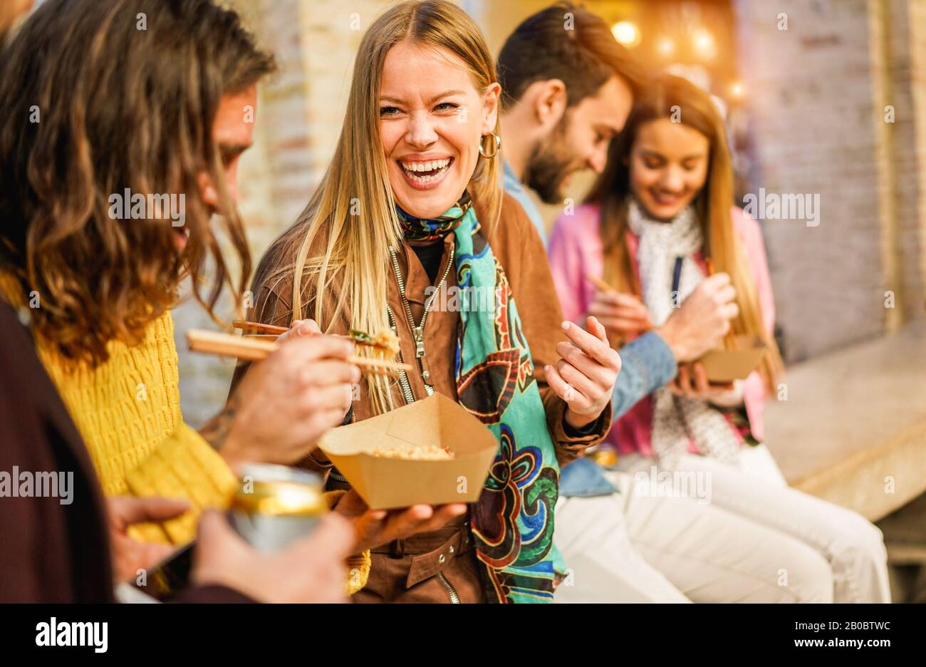 Happy friends eating street food outdoor - Young trendy people having ...