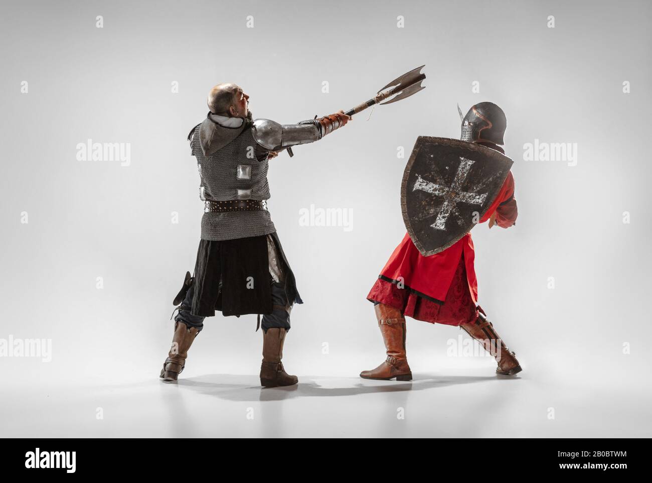 Brave armored knights with professional weapon fighting isolated on ...