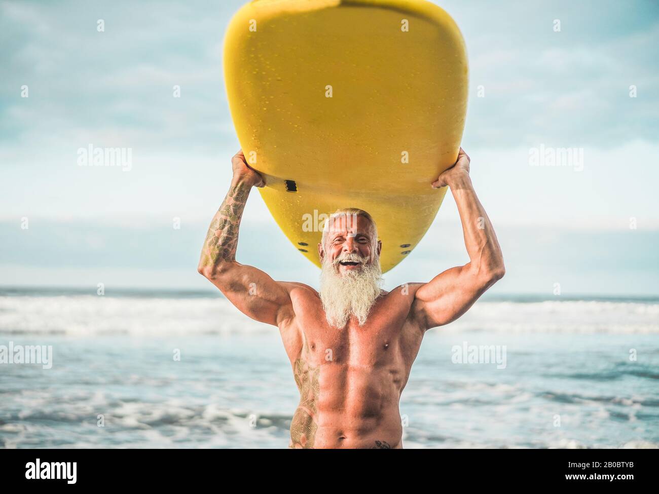 Senior trendy man doing surf with longboard - Happy old guy having fun ...
