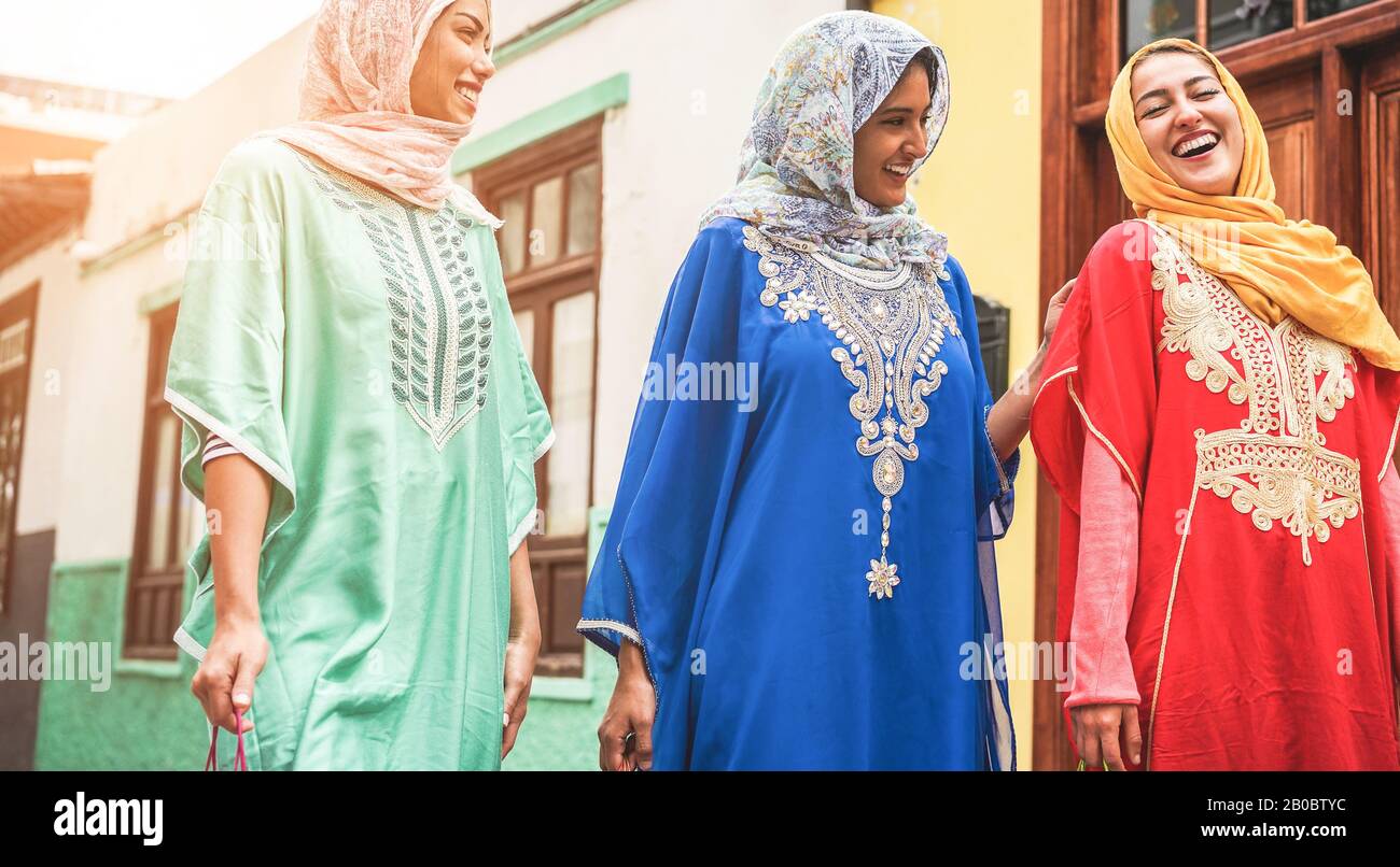 Happy arabic friends walking in city center - Young arabian women ...