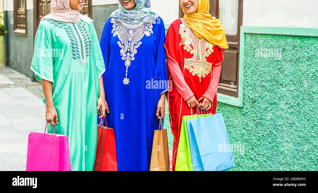 Happy muslim friends going back at home after shopping - Young islamic ...