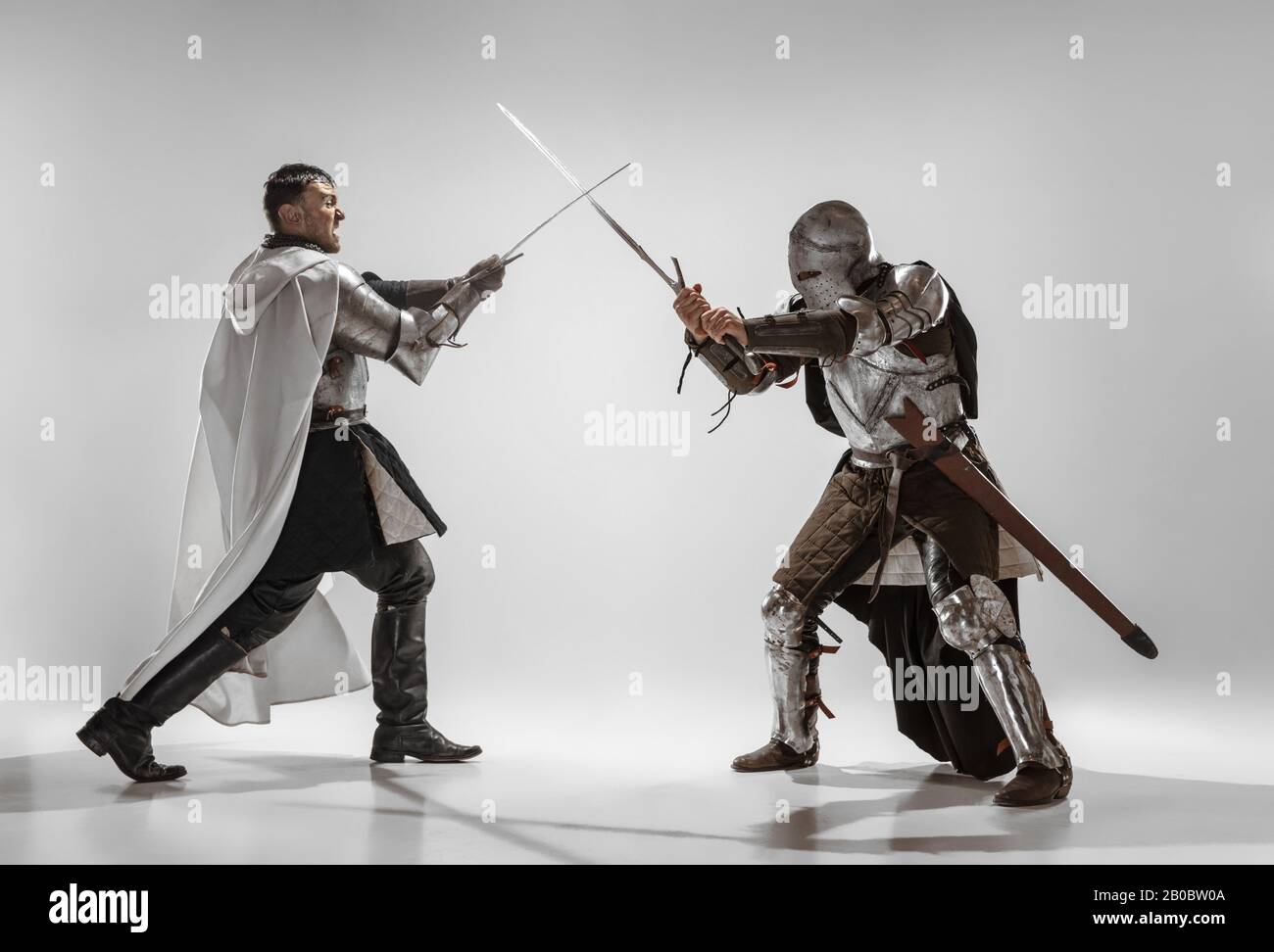 Brave armored knights with professional weapon fighting isolated on ...