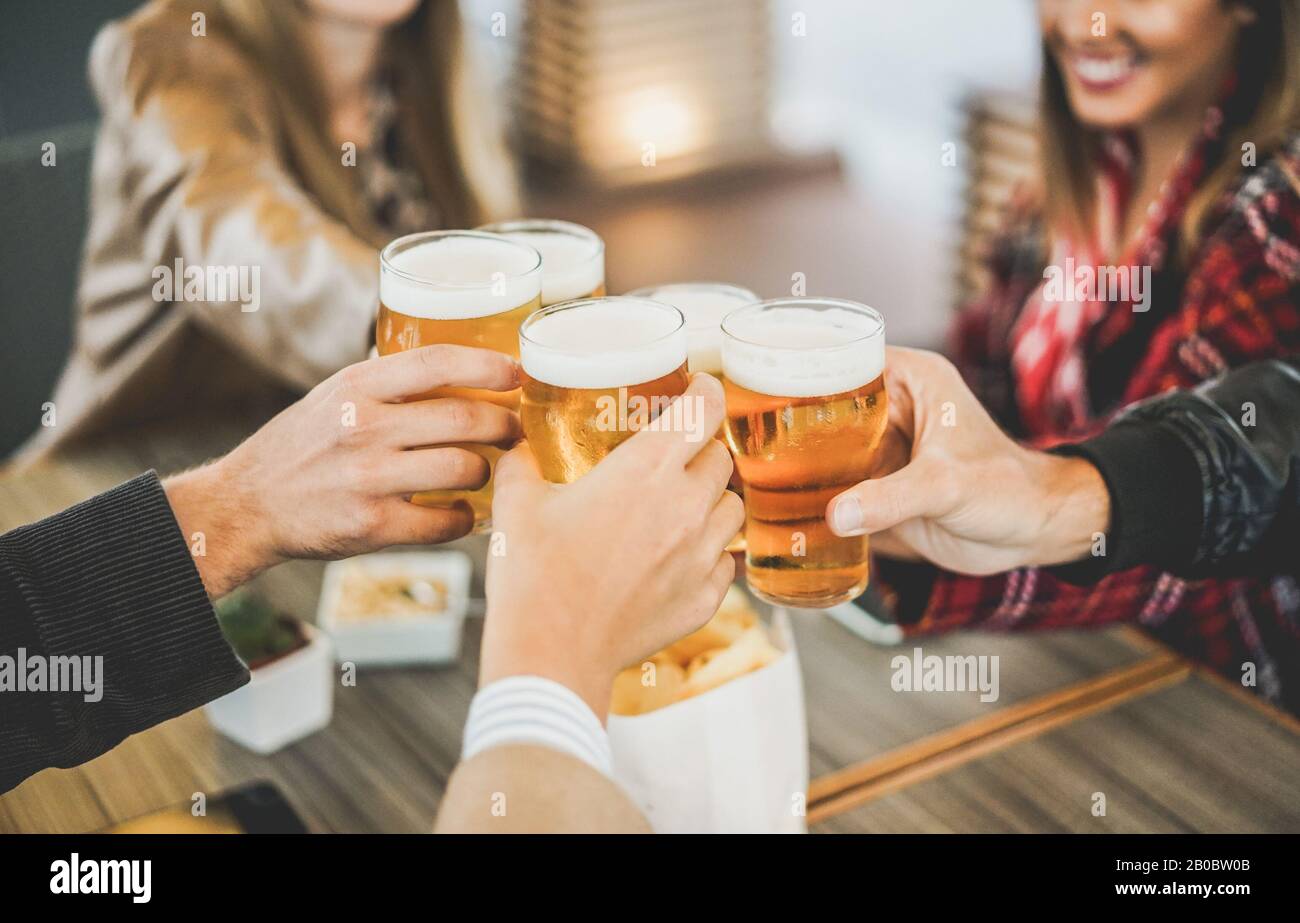 Group Of Friends Enjoying A Beer In Brewery Vintage Pub Young People