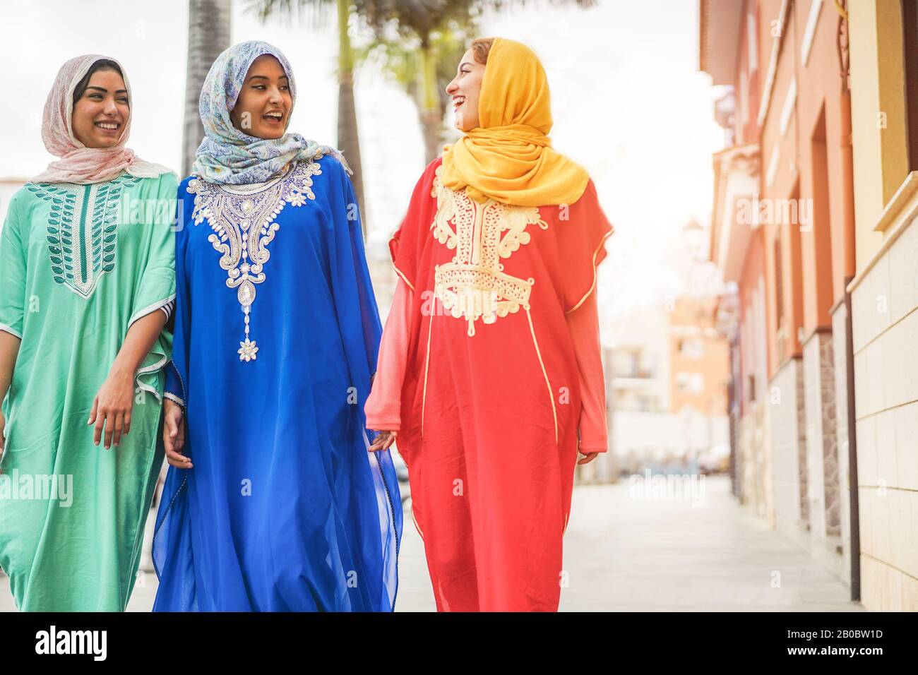 Happy arabic friends walking in city center - Young arabian women ...