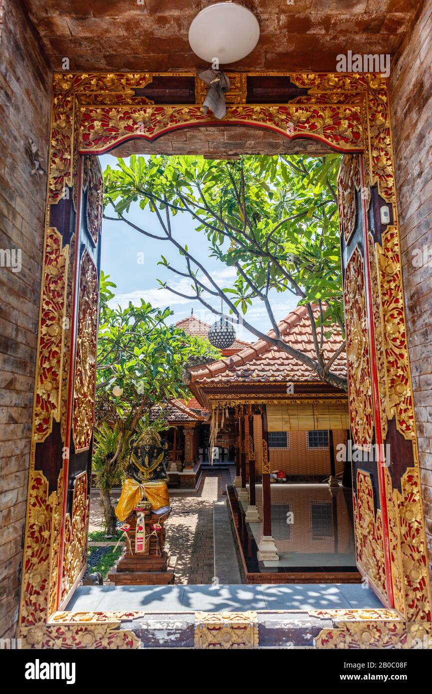 Hindu temple entrance gates with wooden carved doors and statues ...