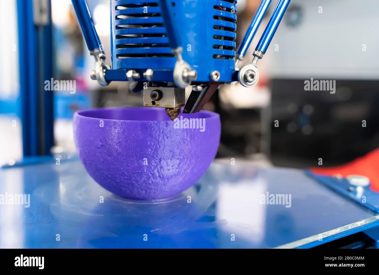 3D printer or additive manufacturing and robotic automation technology ...