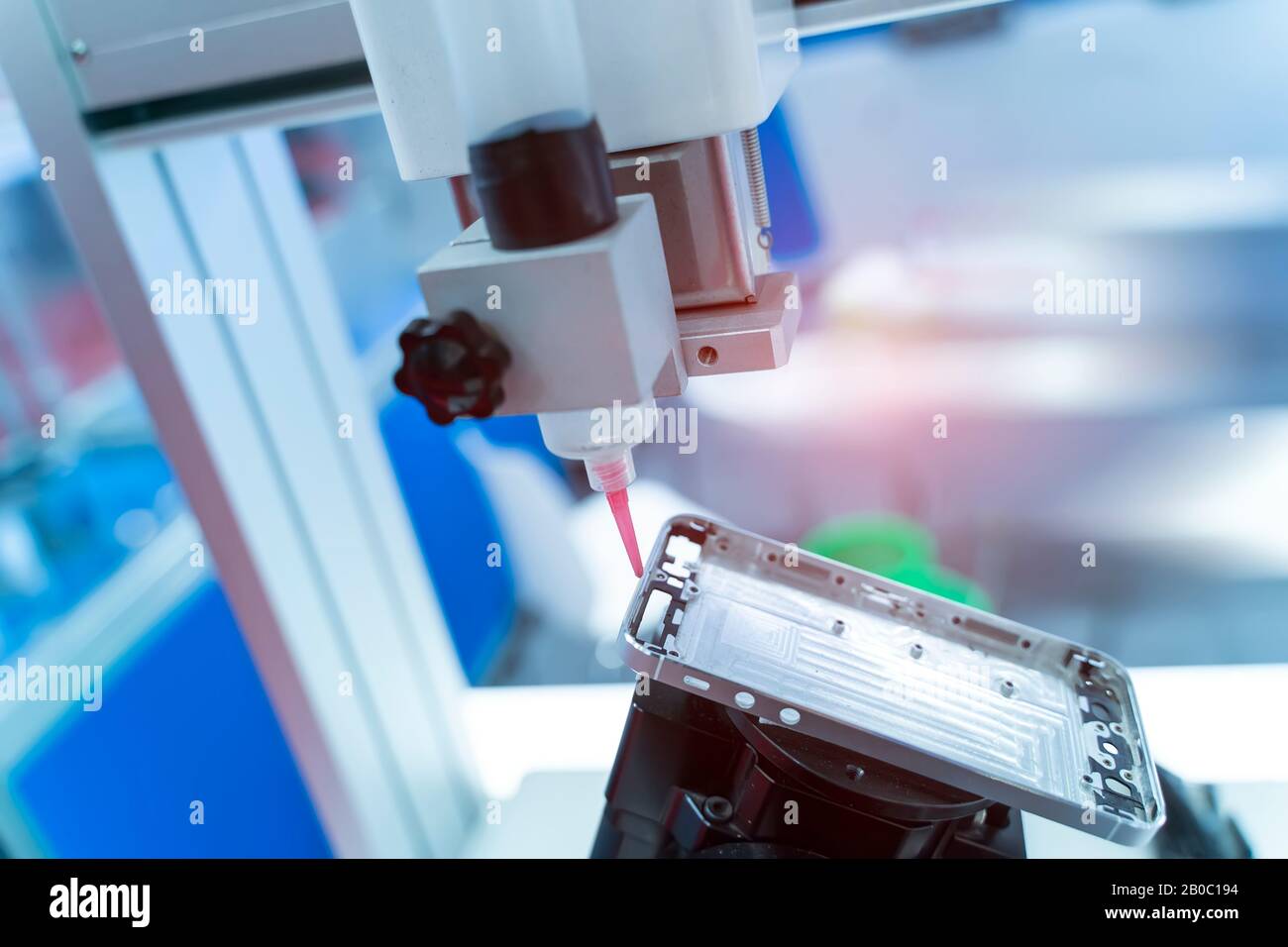 Robot holding glue syringe Injection in mobile phone factory Stock ...