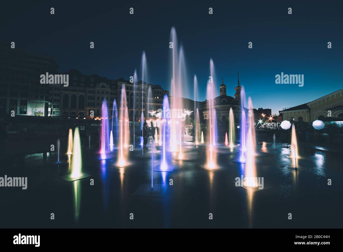 Musical fountain with colorful illumination at night with reflection ...