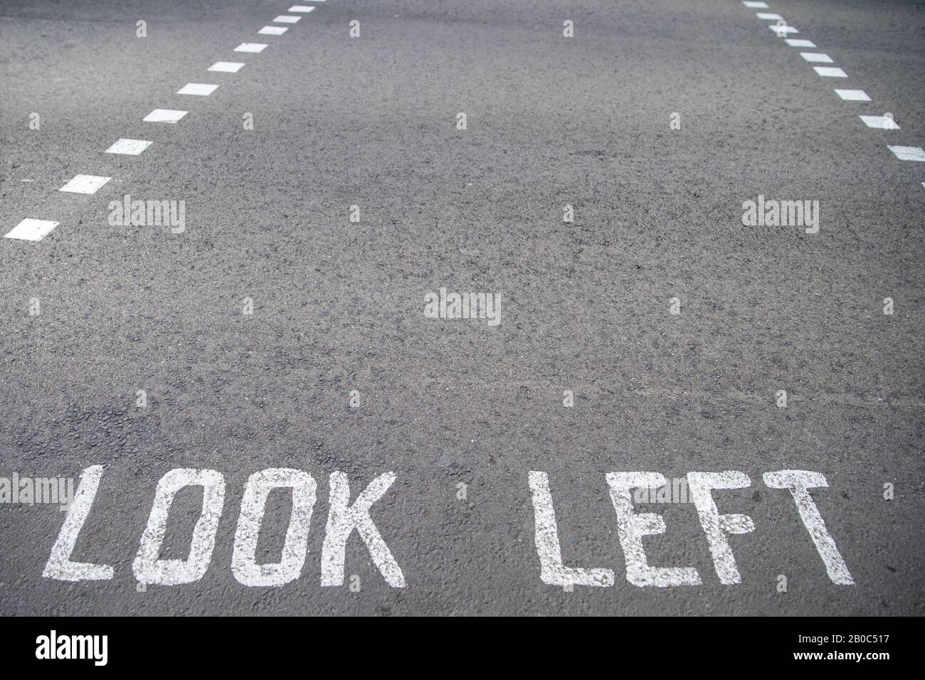 The inscription Look Left on a pedestrian crossing on the street Stock ...