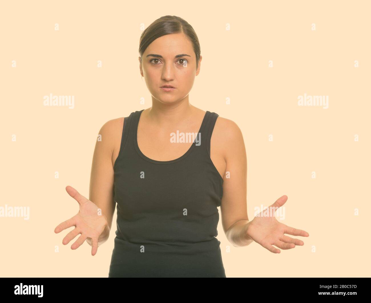 Studio shot of beautiful woman looking confused Stock Photo - Alamy