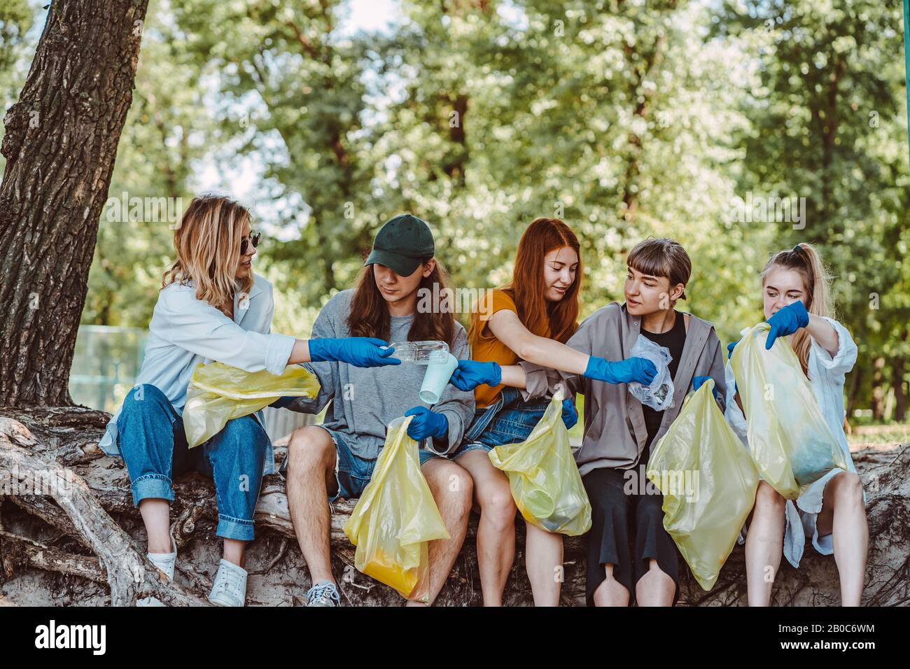 Group of activists friends collecting plastic waste at the park ...