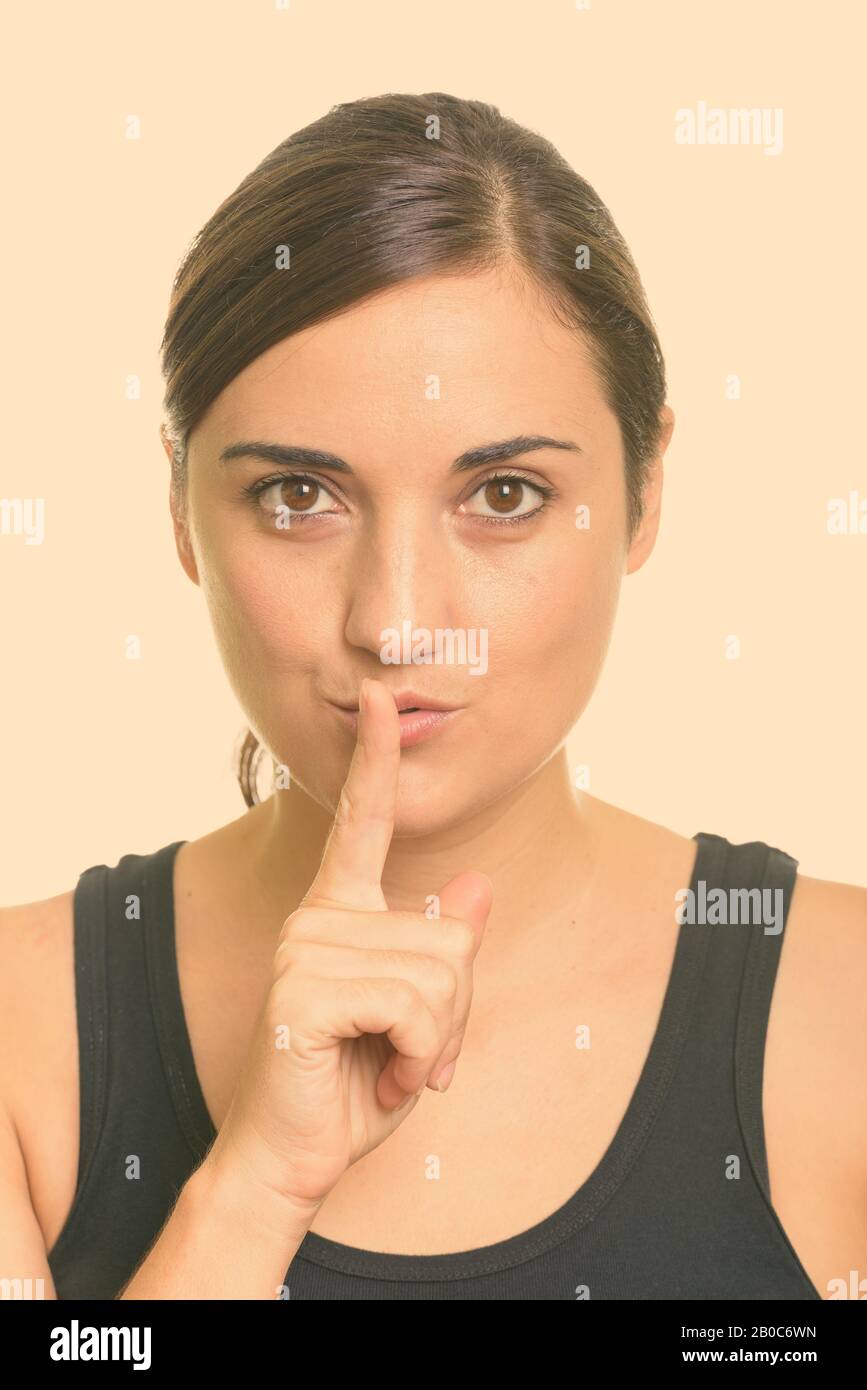 Face of beautiful woman with finger on lips Stock Photo - Alamy