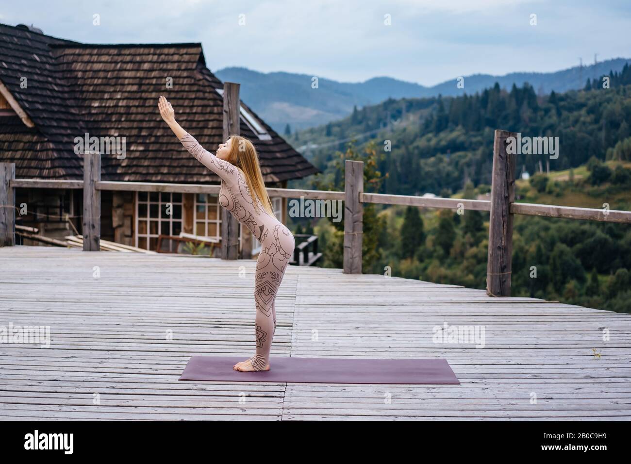 A woman practices yoga at the morning in a terrace on a fresh air Stock ...
