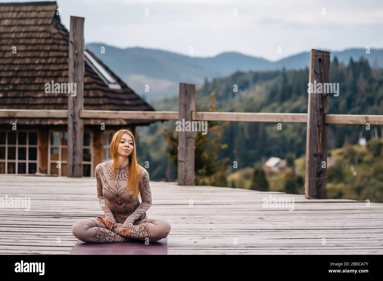 A woman sitting in lotus position at the morning on a fresh air Stock ...