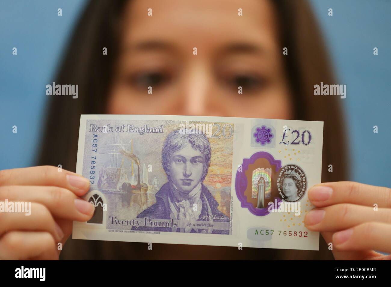 Tate Britain, London, UK 20 Feb 2020 - A staff member holds the new £20 ...